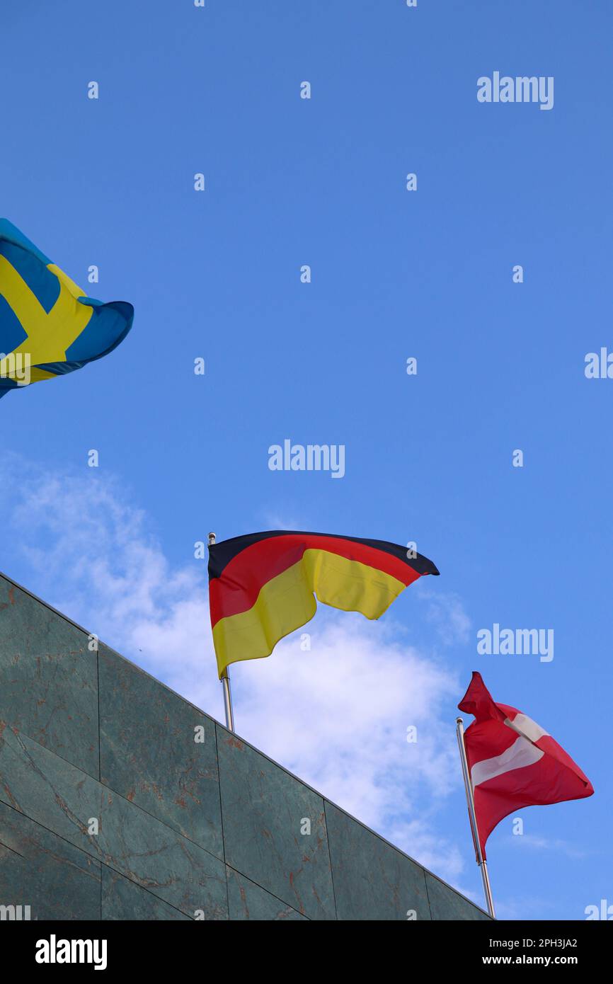 The Germany Flag Waving on Top of the Building with Other Nations Flags ...