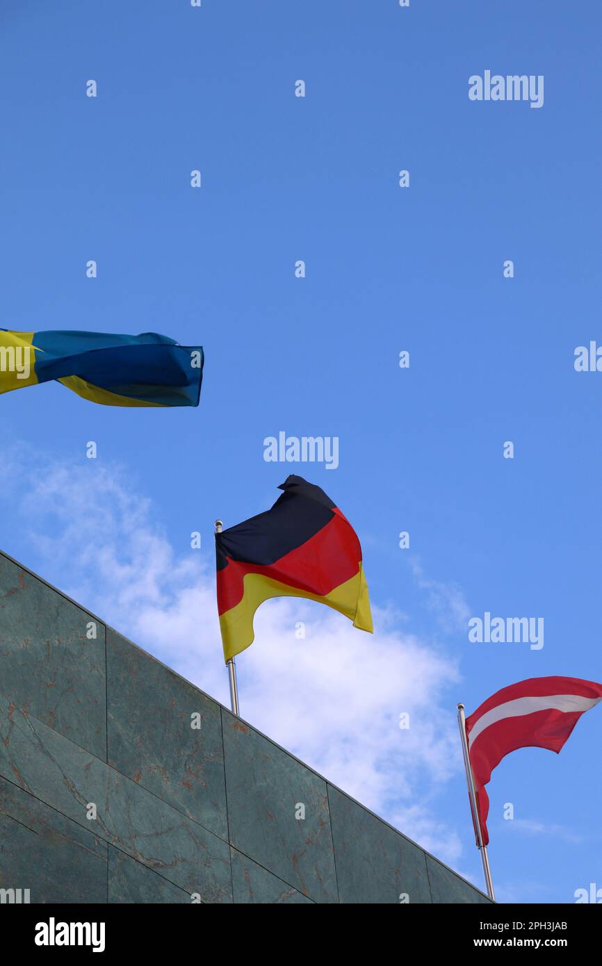 The Germany Flag Waving on Top of the Building with Other Nations Flags ...