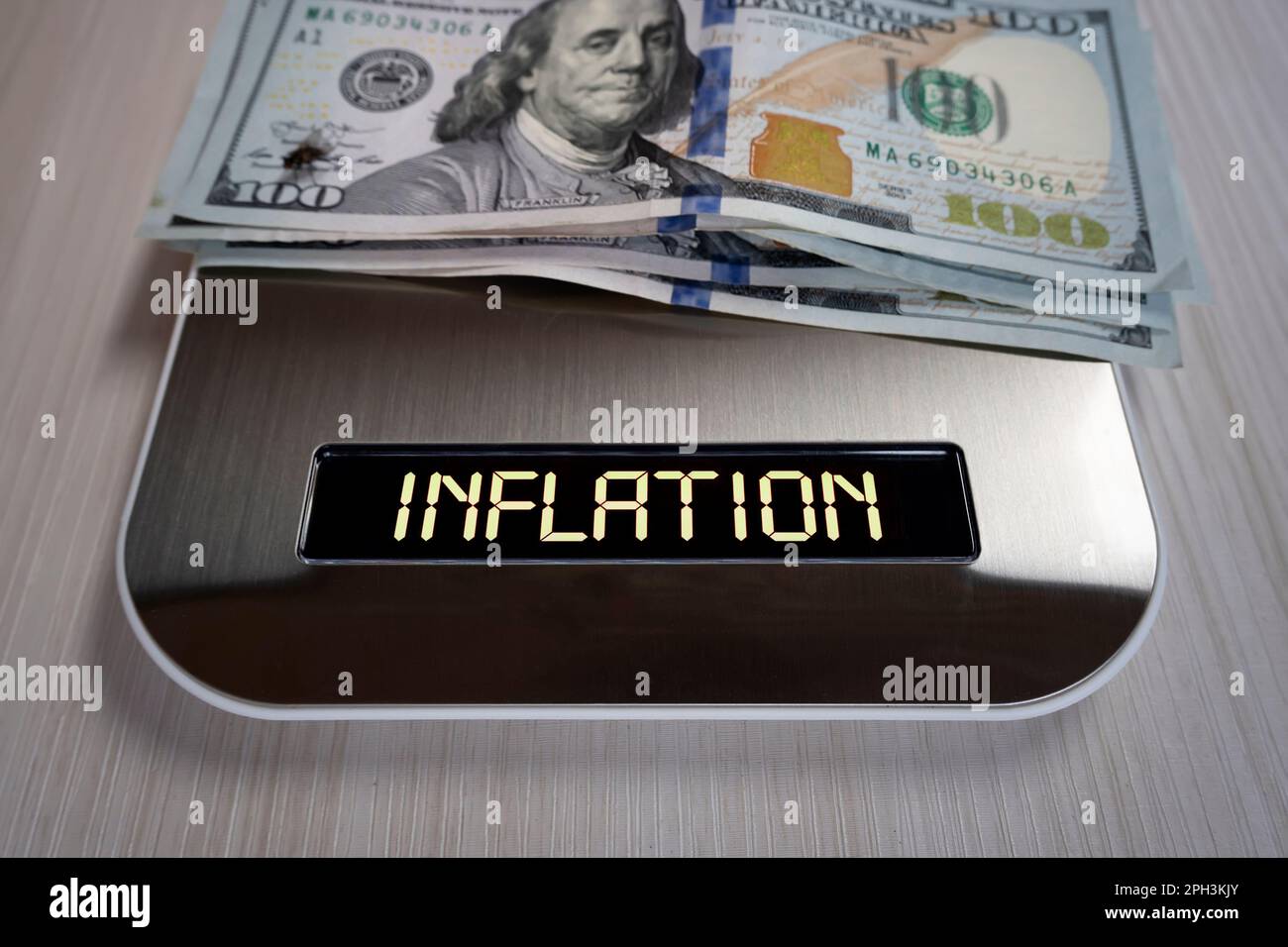 Dollar bills on the electronic scales, a symbol of cost reduction ...