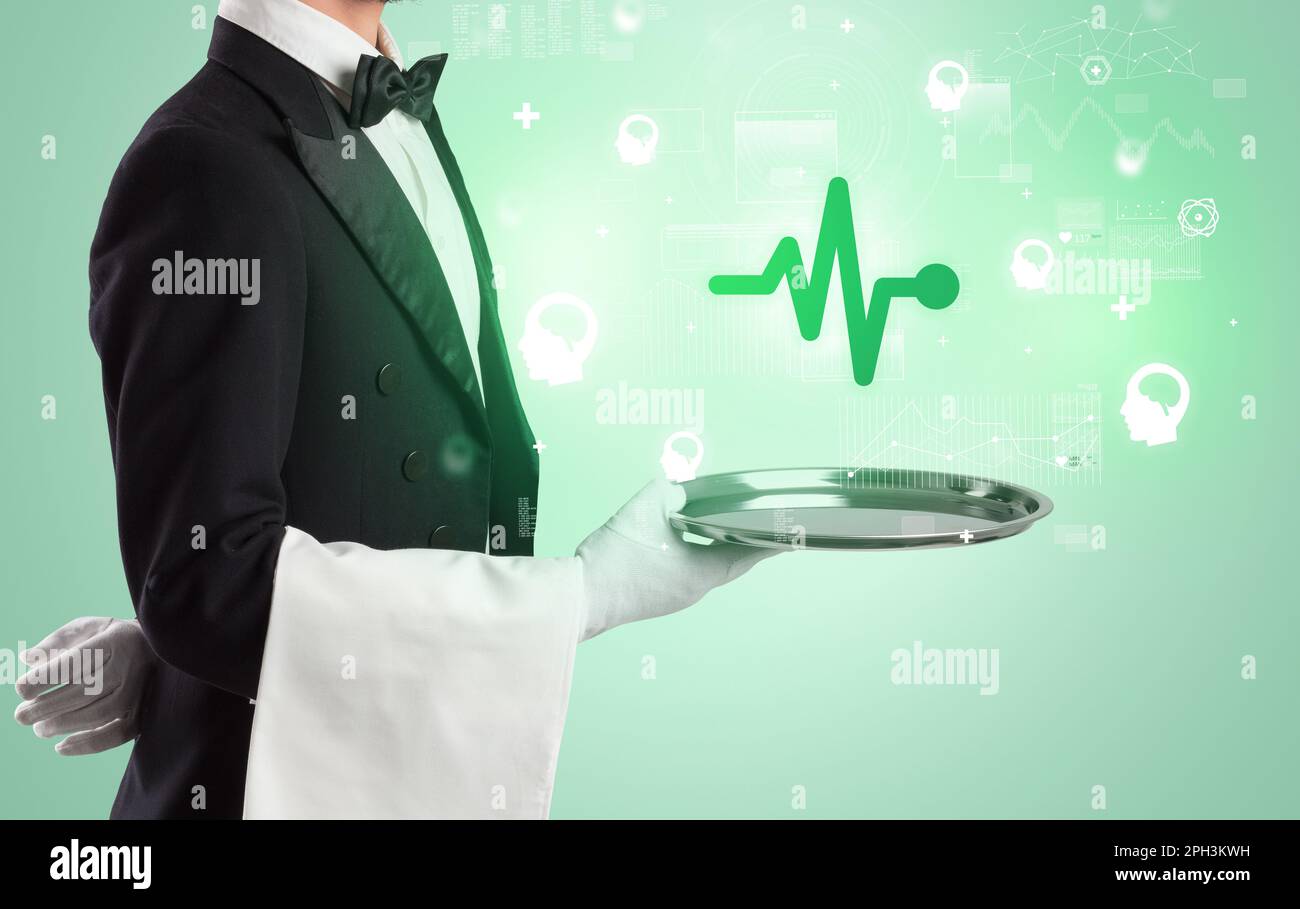 Handsome young waiter in tuxedo holding healthcare icons on tray Stock ...