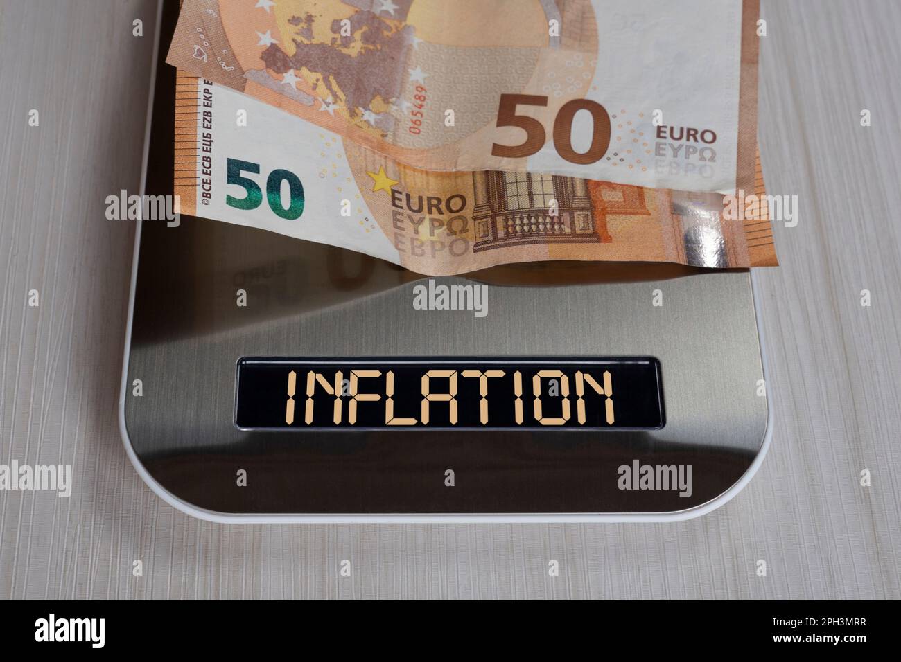 euro bills on the electronic scales, a symbol of cost reduction ...