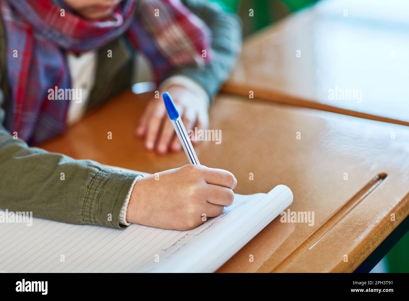 Writing down her dreams. an unrecognizable elementary school girl ...