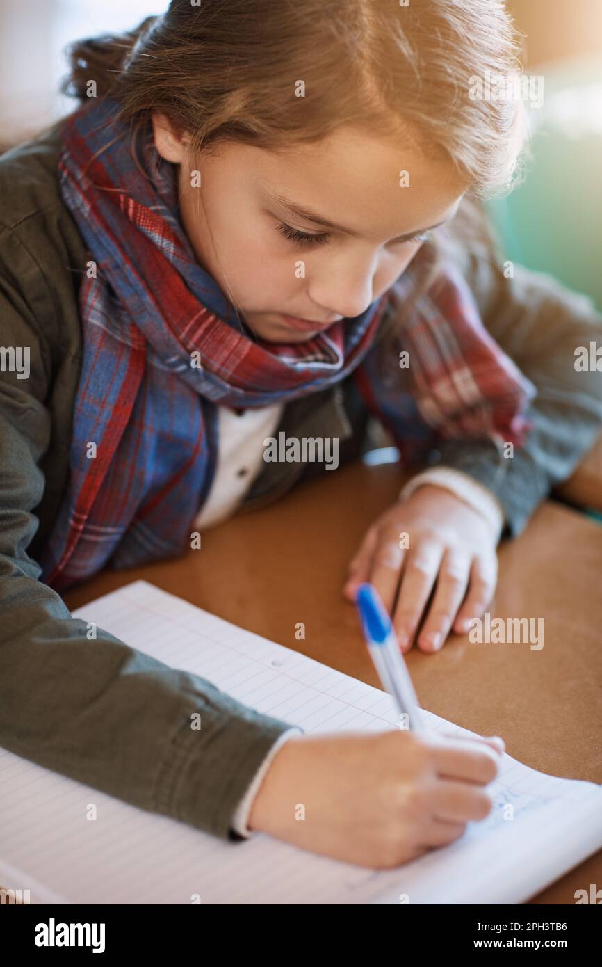 Shes all about finishing her schoolwork. an elementary school girl ...