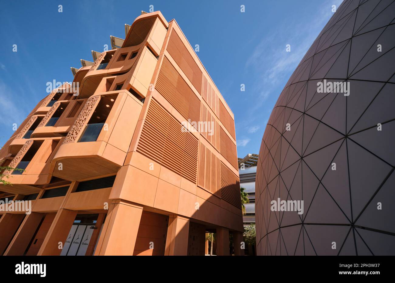 View of the orange terracotta clad mixed use apartment building facades ...