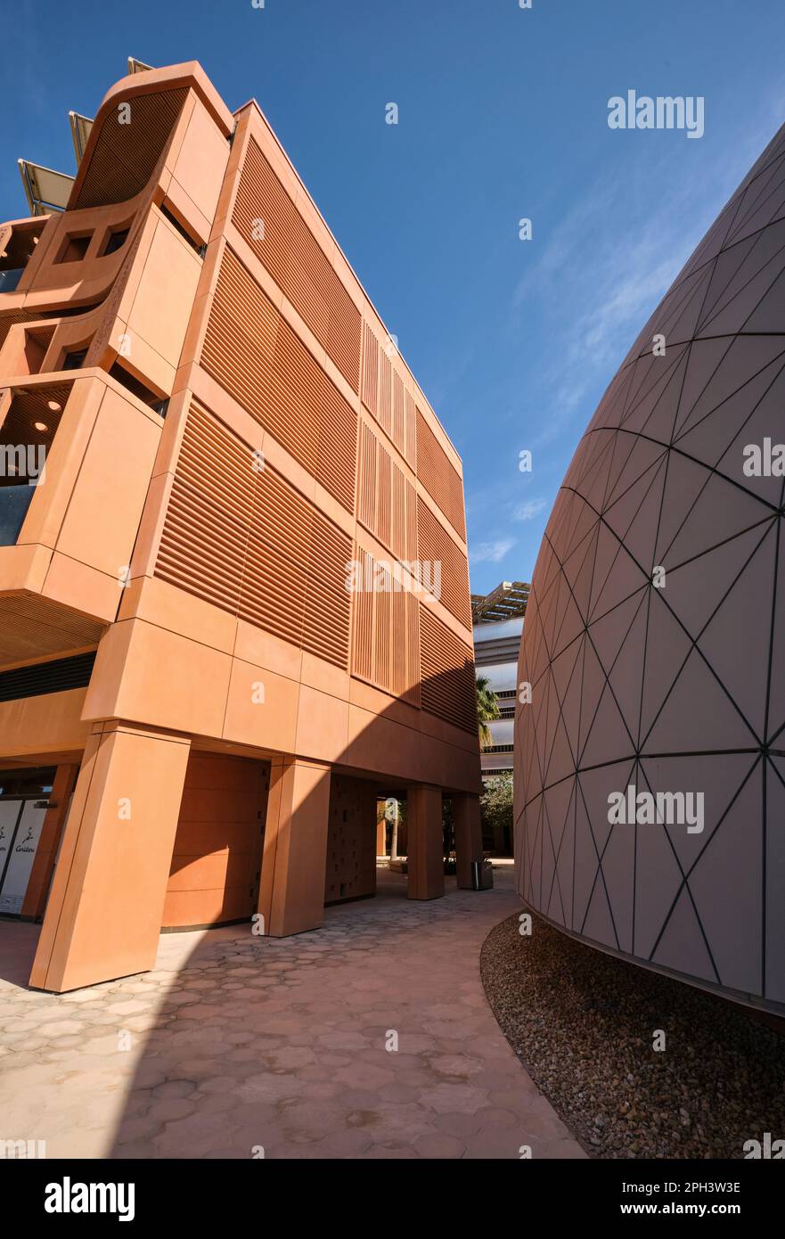 View of the orange terracotta clad mixed use apartment building facades ...