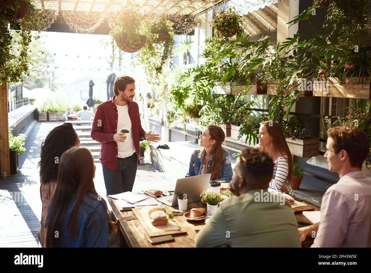 Discussing ideas over lunch. a handsome young man addressing his ...