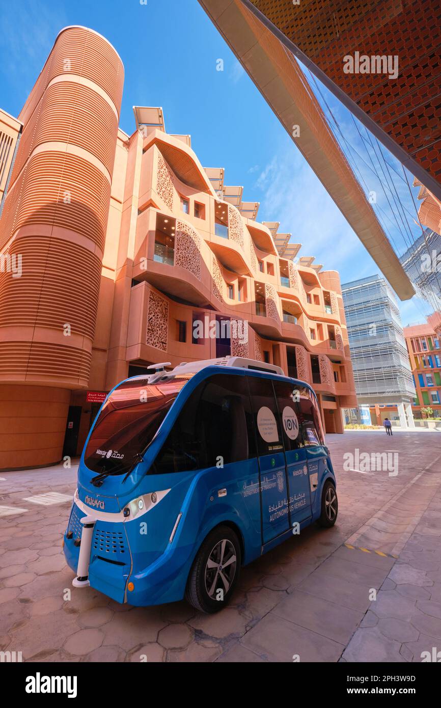 Orange terracotta clad mixed use apartments with blue, electric ...