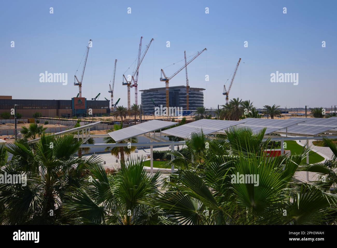 A big construction site with cranes, next to the shopping mall. At ...