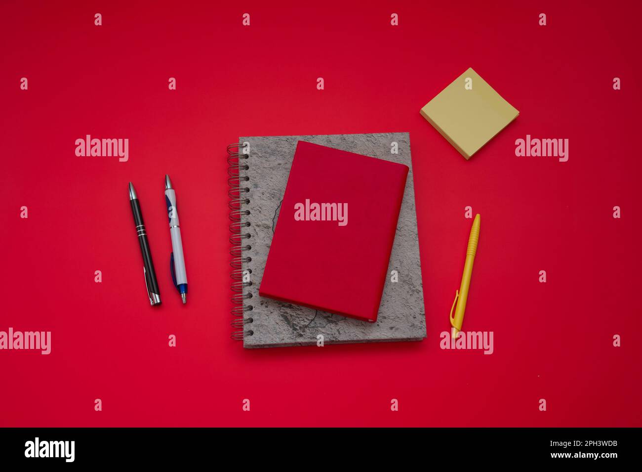 Office supplies stationery on a red background Stock Photo - Alamy