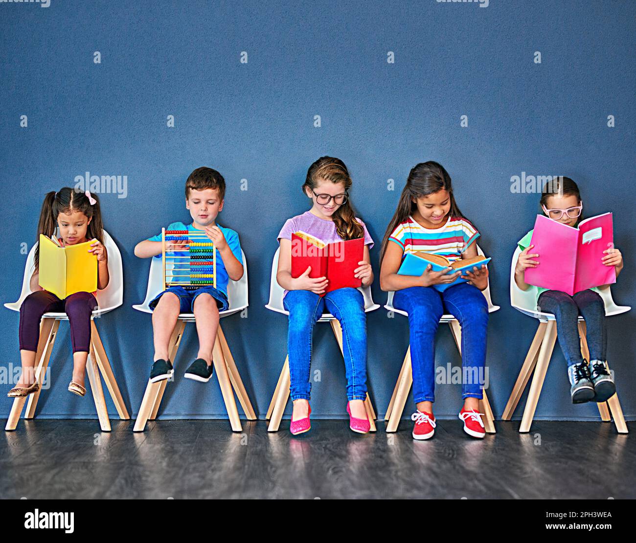 Knowledge is key to growth. Studio shot of a group of kids sitting on ...