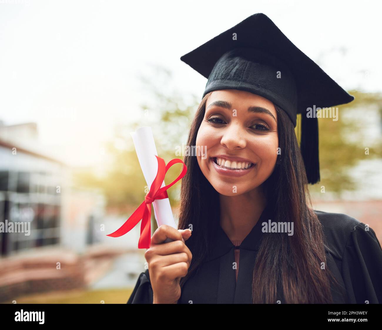 I worked really hard for this. a happy young graduate standing outside ...