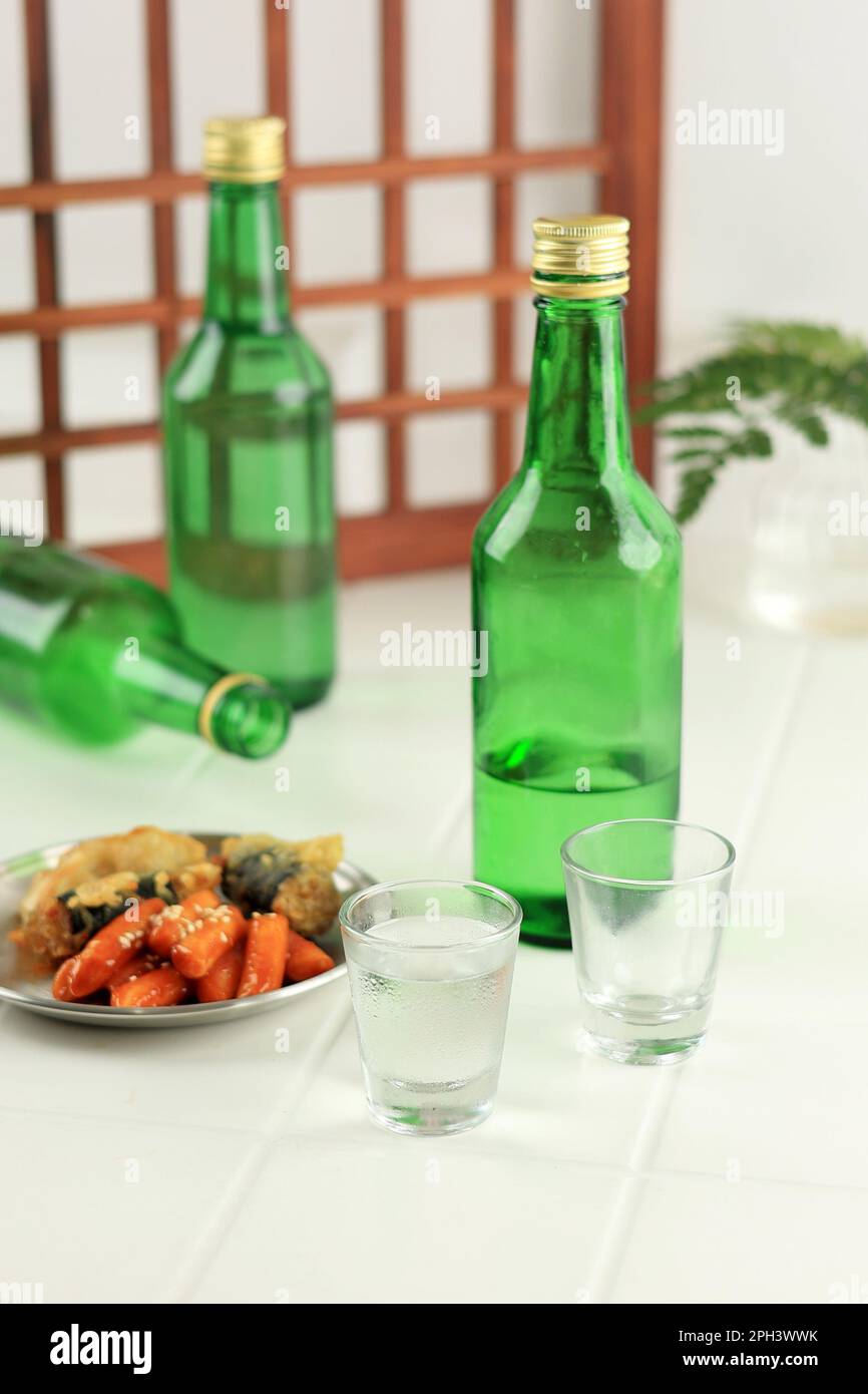 Soju Bottle And Small Glass Cup Served With Anju Alcoholic Clear Distilled Korean Soju Stock