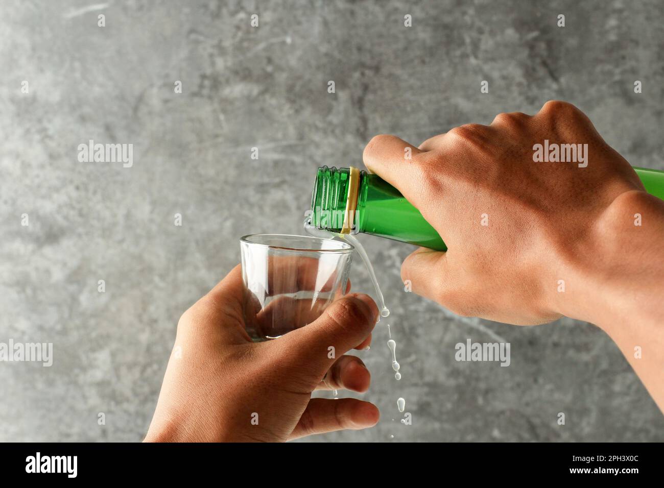 Mand Hand Pour Soju Korean Alcohol to the Sloki Glass, Copy Space Stock ...