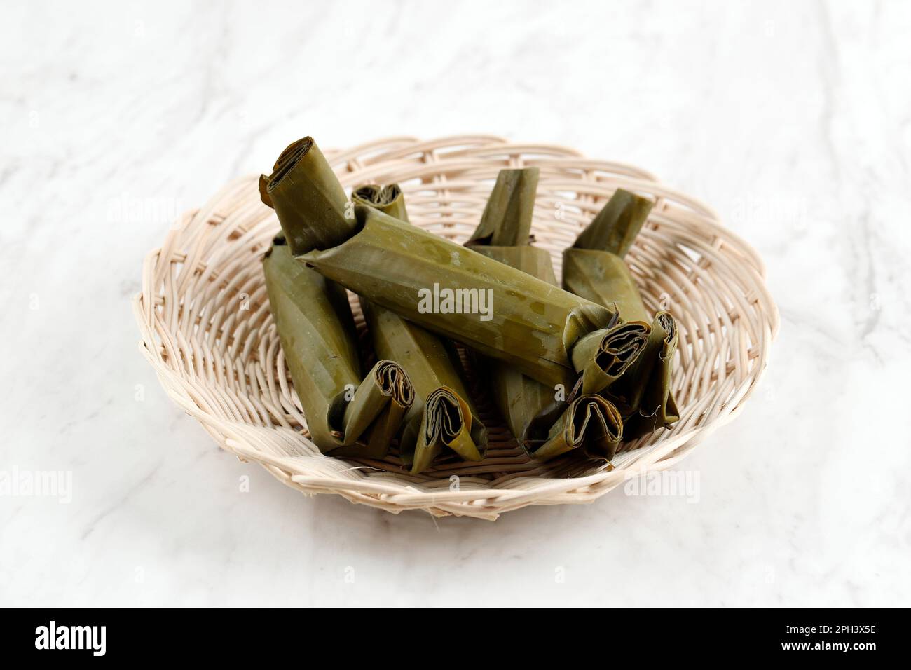 Lontong, Indonesian Rice Cake Wrapped with Banana Leaf, on Rattan Plate ...