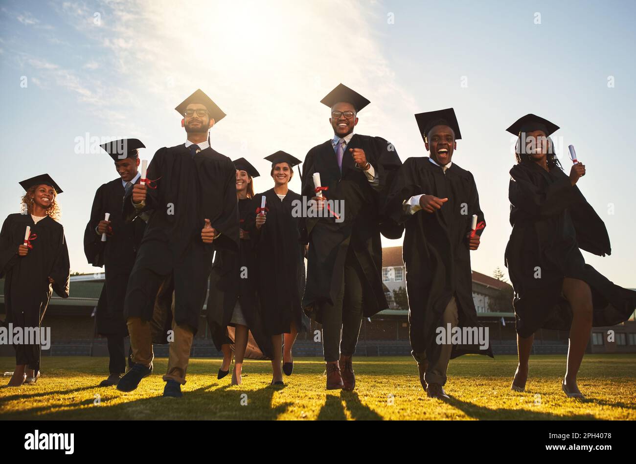 Your future awaits you. a group of university students running after ...