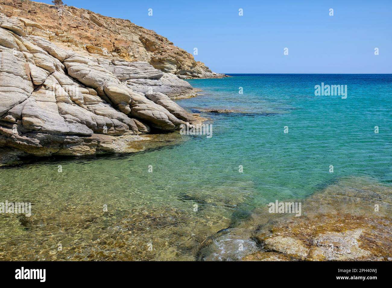 View of the rocky landscape next to the beach of Plakes in Ios Greece ...