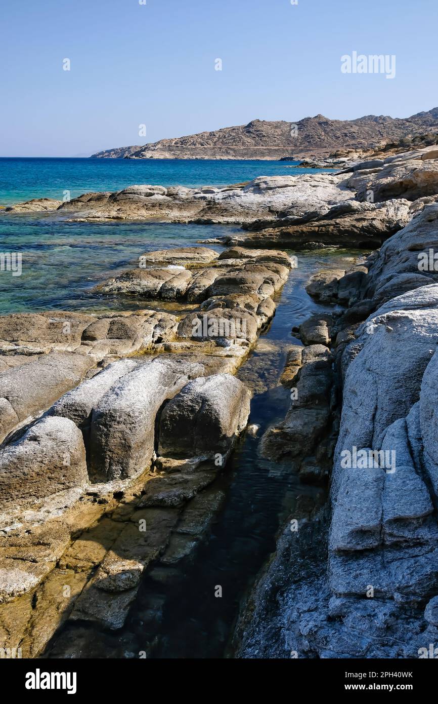 View of the rocky landscape next to the beach of Plakes in Ios Greece ...
