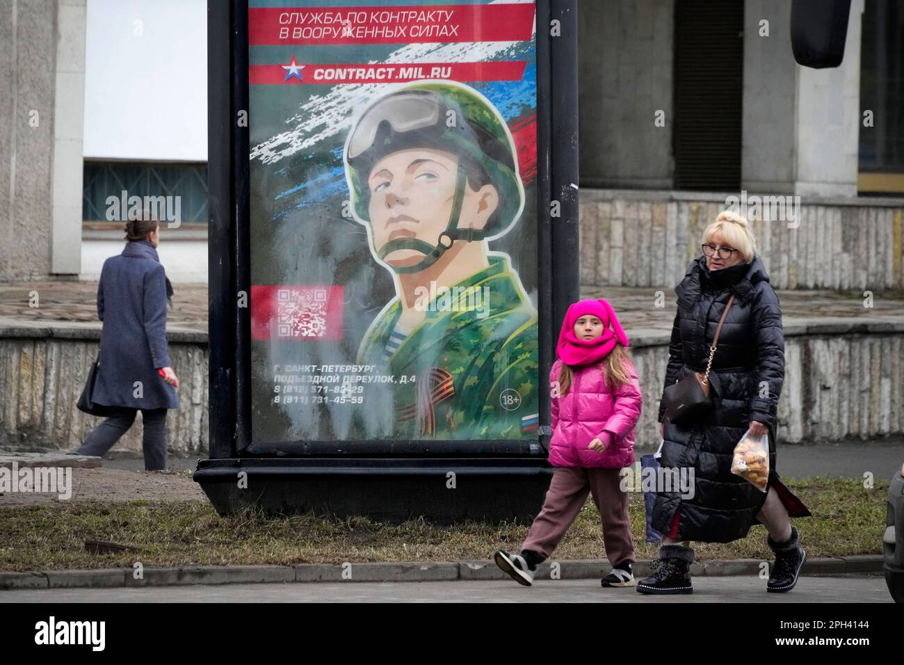 People walk past an army recruiting billboard with the words "Military ...