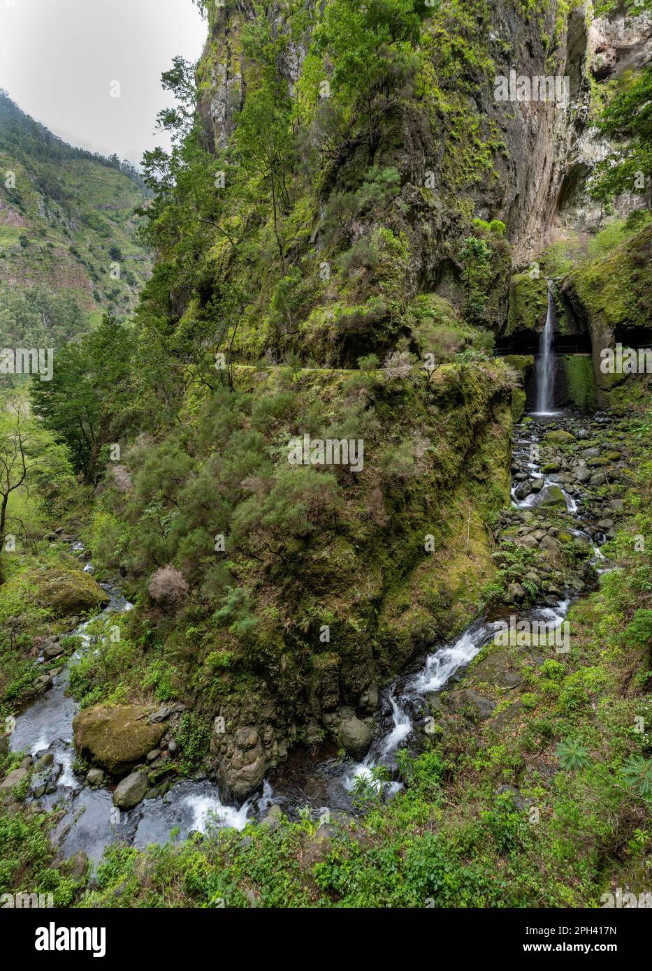 Nova waterfall and Moinho in a gorge, hiking trail at Levada Nova, long ...