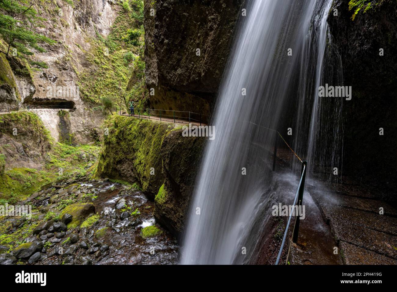 Hikers at Levada Nova, Nova waterfall and Moinho in a gorge, long ...