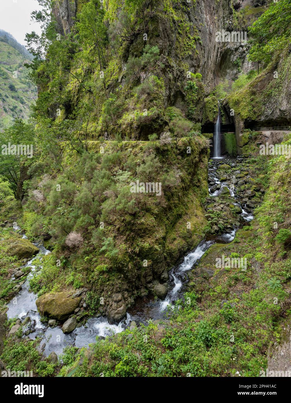 Nova waterfall and Moinho in a gorge, hiking trail at Levada Nova, long ...
