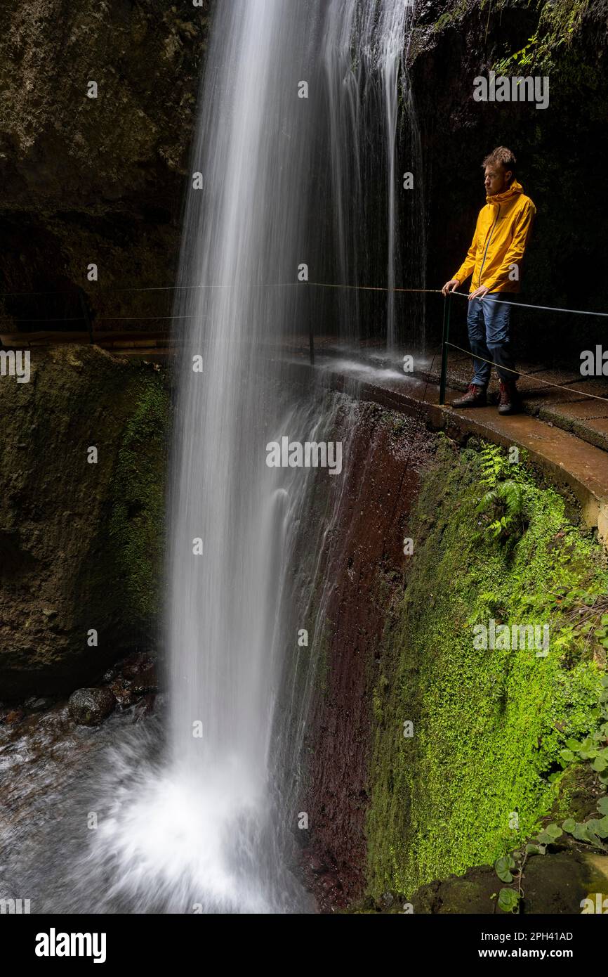 Hikers at Levada Nova, Nova waterfall and Moinho in a gorge, long ...