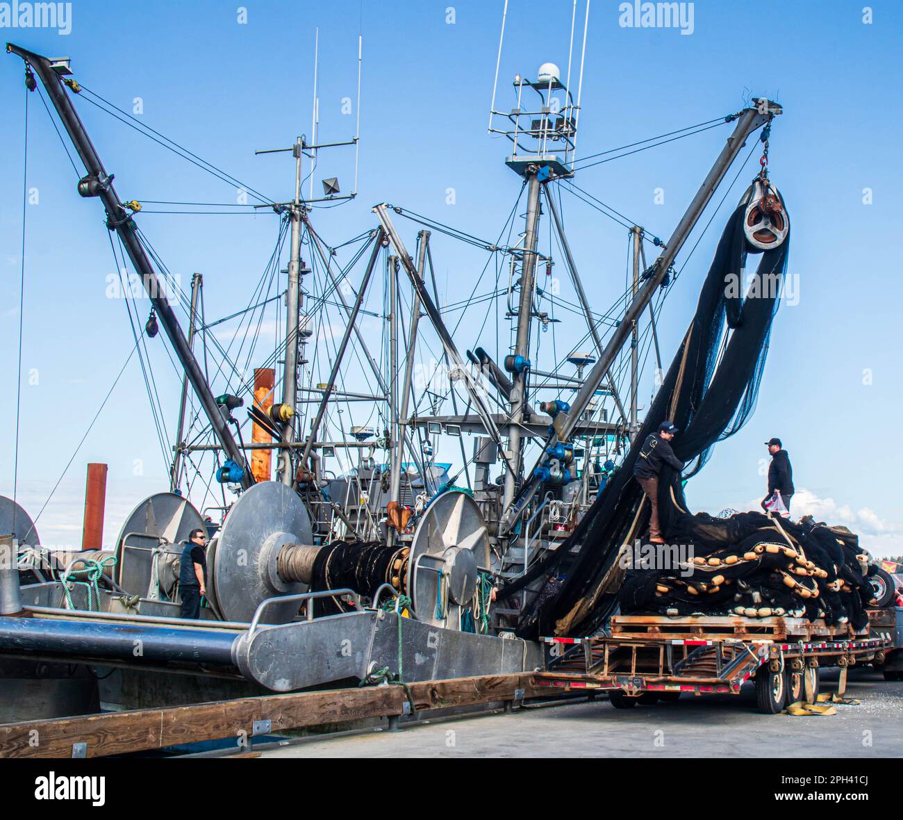 Two Canadian Seine boats at dock, getting nets ready for fishing season ...