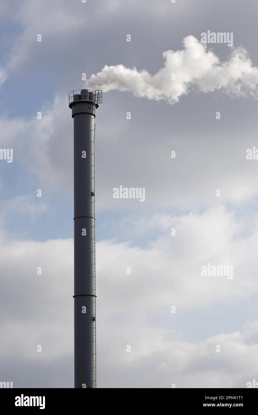 industrial chimney or smokestack emitting white smoke into atmosphere ...