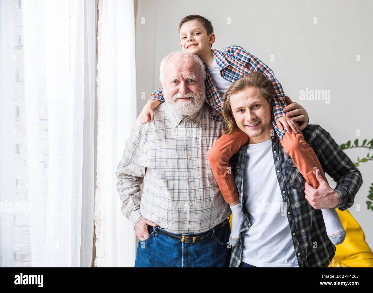 men different generations standing embracing Stock Photo - Alamy