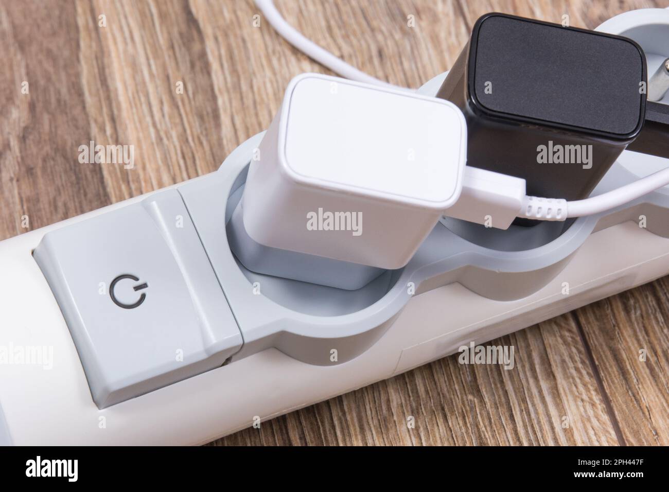 Smartphone, mobile phone chargers connected to electrical power strip ...