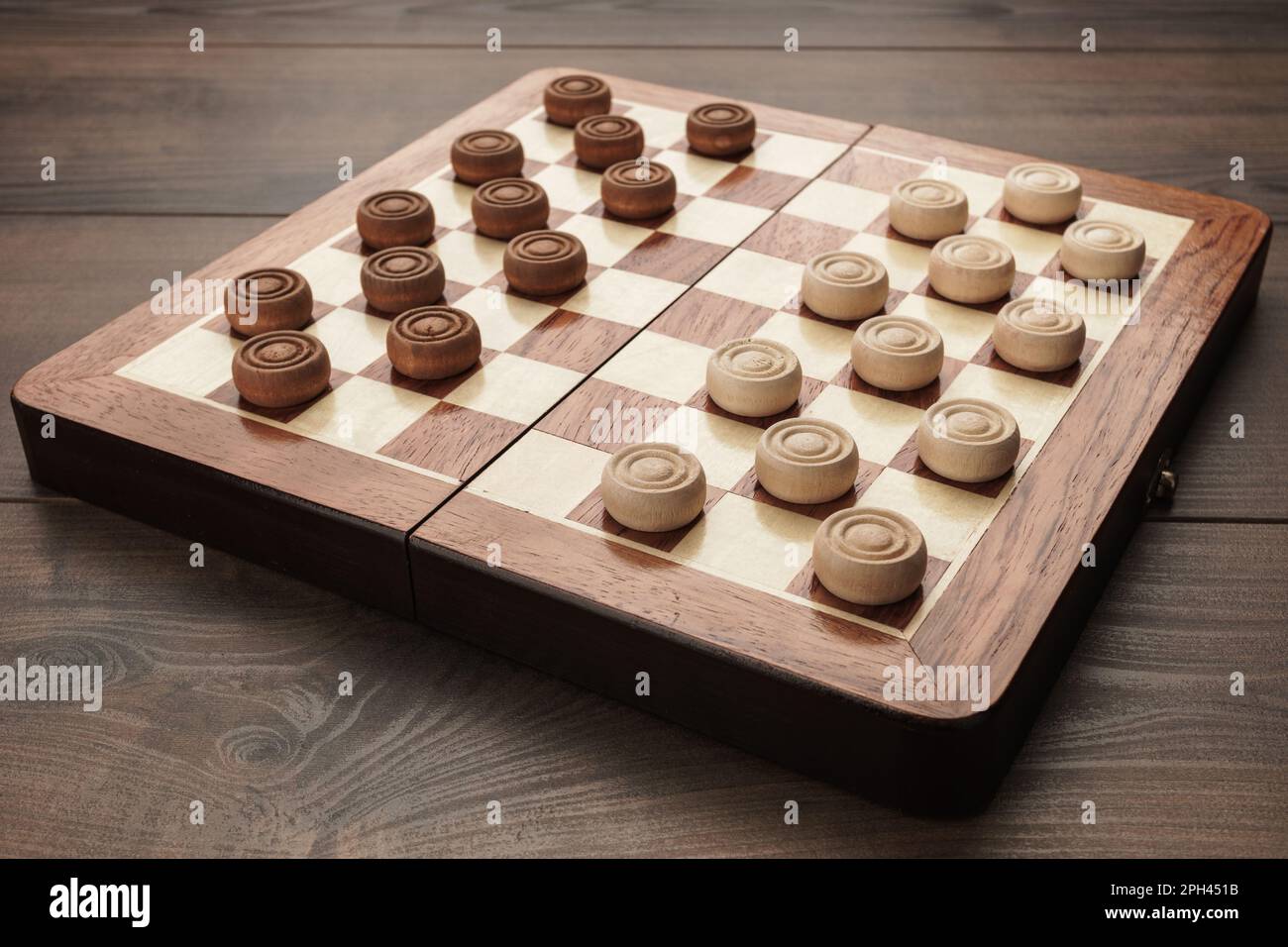 wooden draughts game on brown table background Stock Photo - Alamy