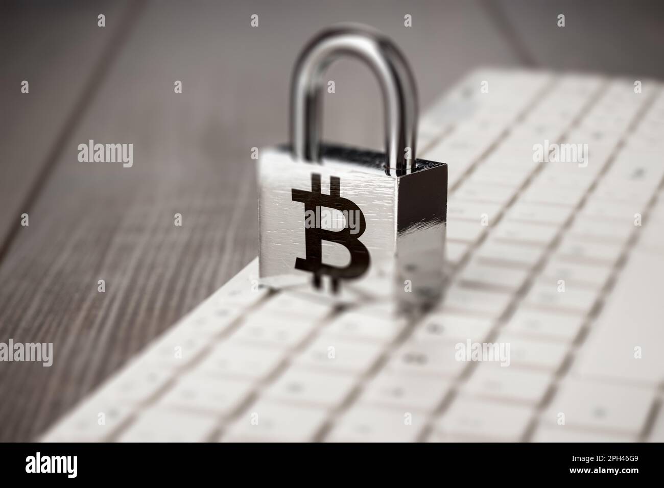 padlock with bitcoin symbol and white computer keyboard on the wooden ...