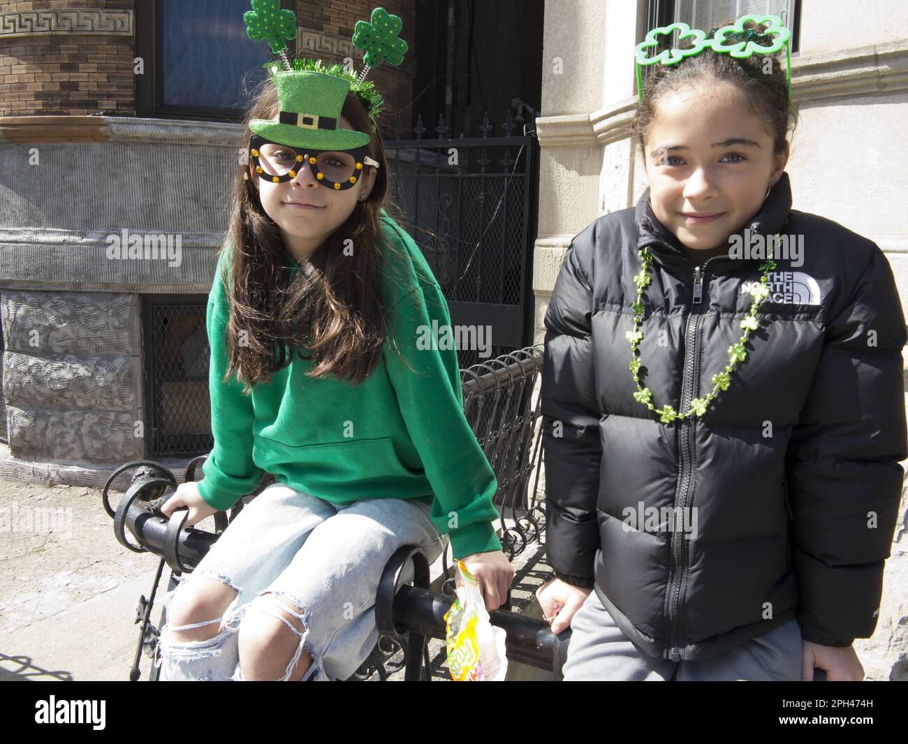Girls watch the St.Patrick's Day Parade in Park Slope, Brooklyn, NY ...