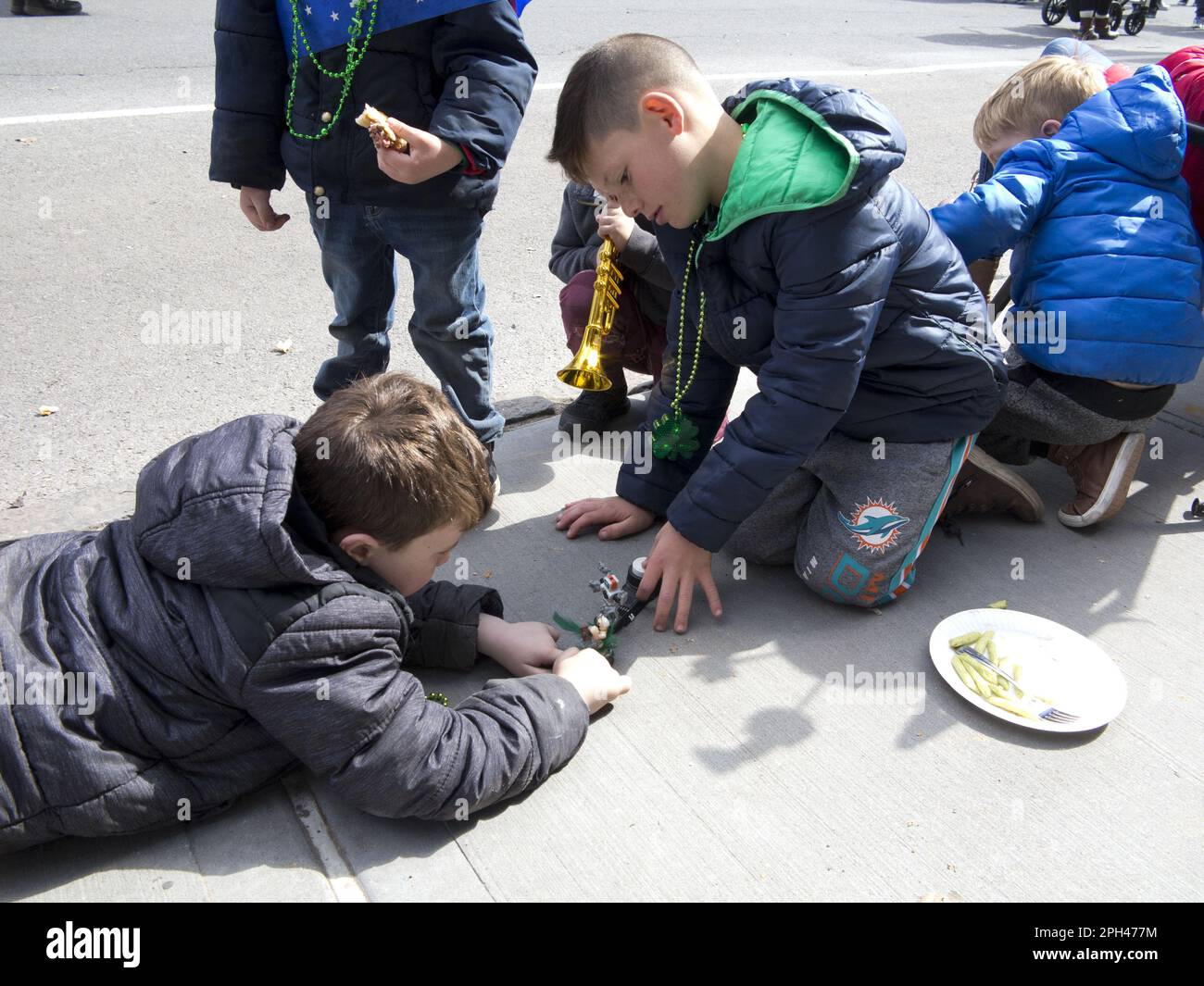 Boys playing on the sidewalk at the St.Patrick's Day Parade in Park ...