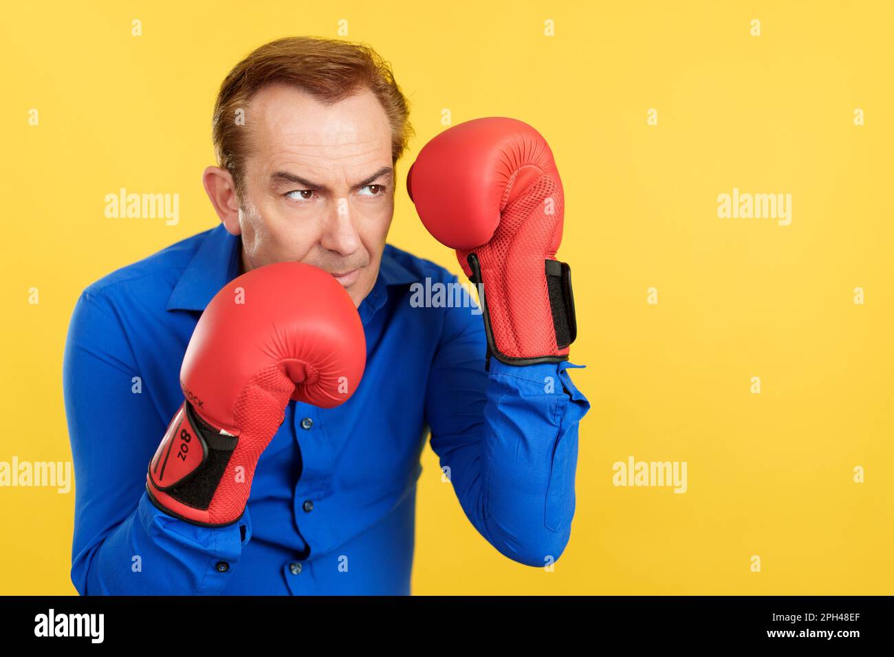 An angry mature man with boxing gloves Stock Photo - Alamy