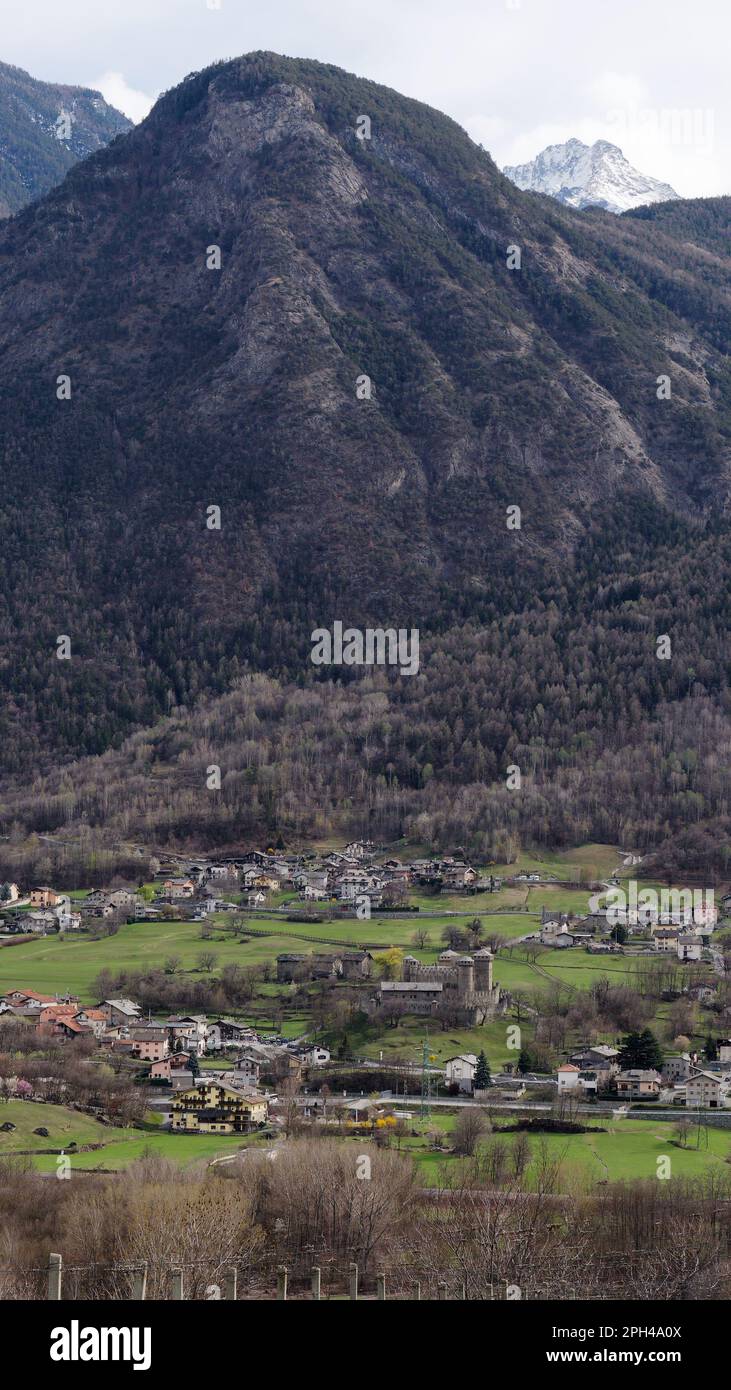 The town of Fenis and its castle set beneath the alps in the Aosta ...