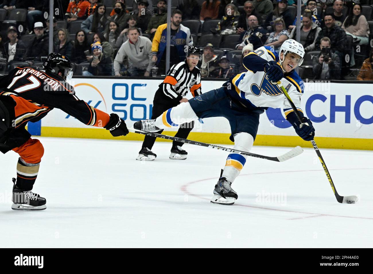 St. Louis Blues center Brayden Schenn, right, shoots the puck with pressure from Anaheim Ducks ...