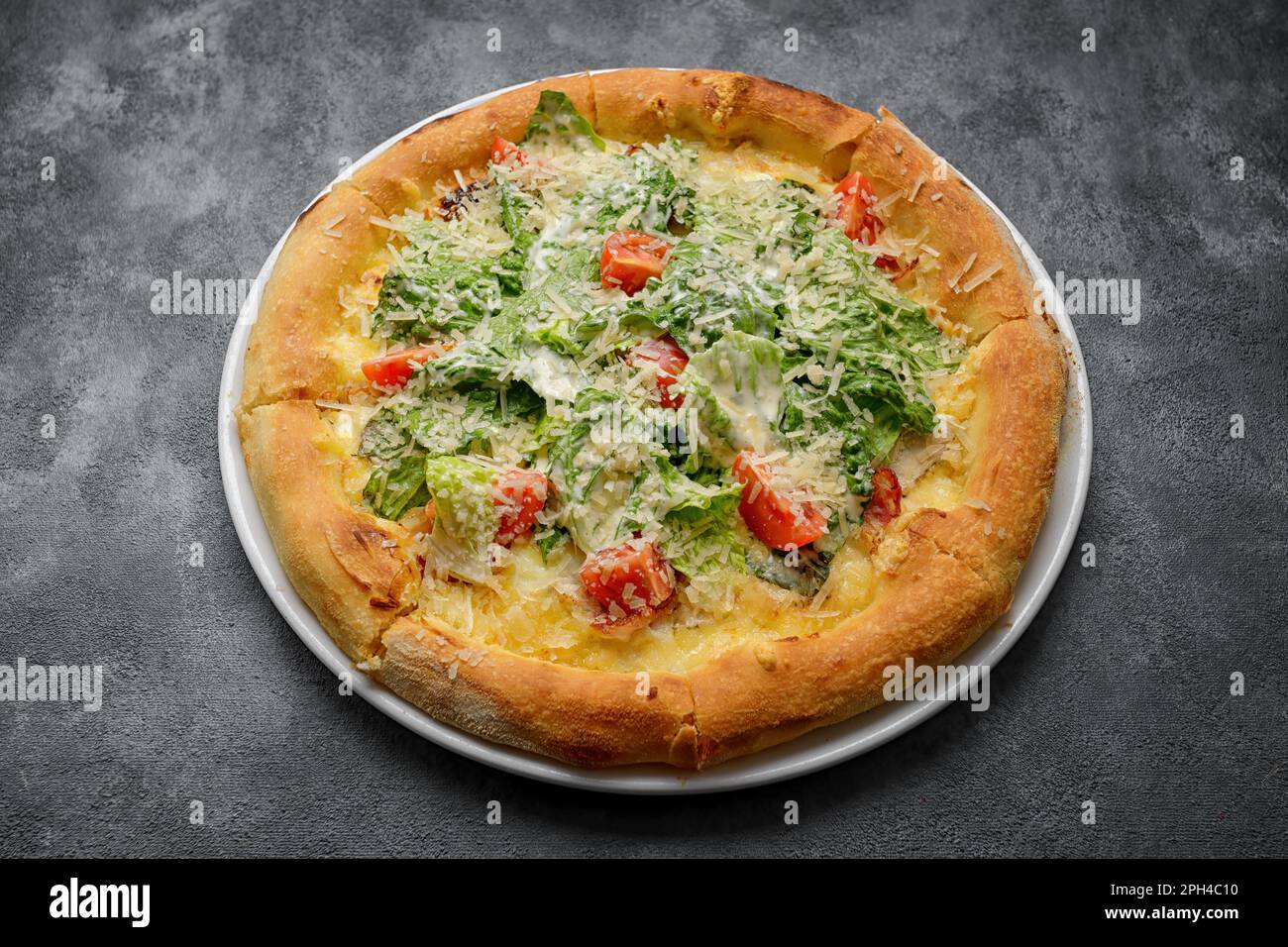 Traditional Caesar pizza displayed on a rustic wood board Stock Photo ...