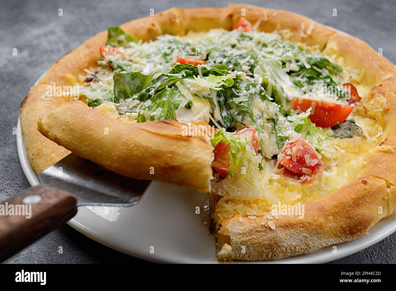 Traditional Caesar pizza displayed on a rustic wood board Stock Photo ...