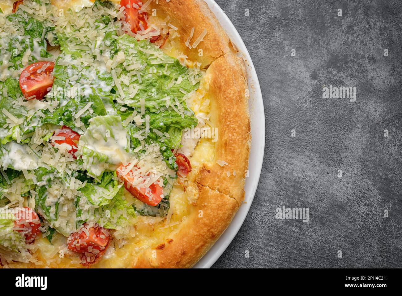 Traditional Caesar pizza displayed on a rustic wood board Stock Photo ...