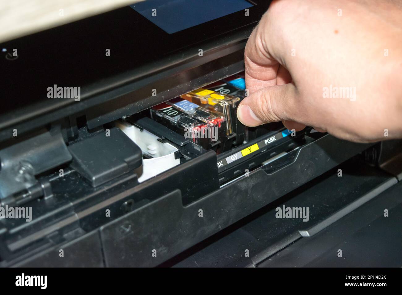 Replacing the ink in the printer, the human hand takes out the ...