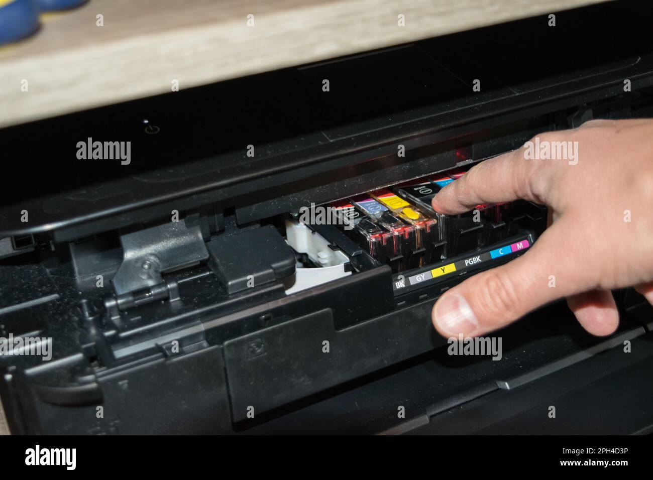 Replacing the ink in the printer, the human hand takes out the ...