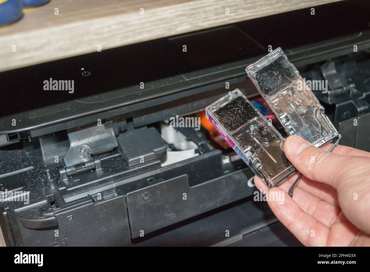 Replacing the ink in the printer, the human hand takes out the ...