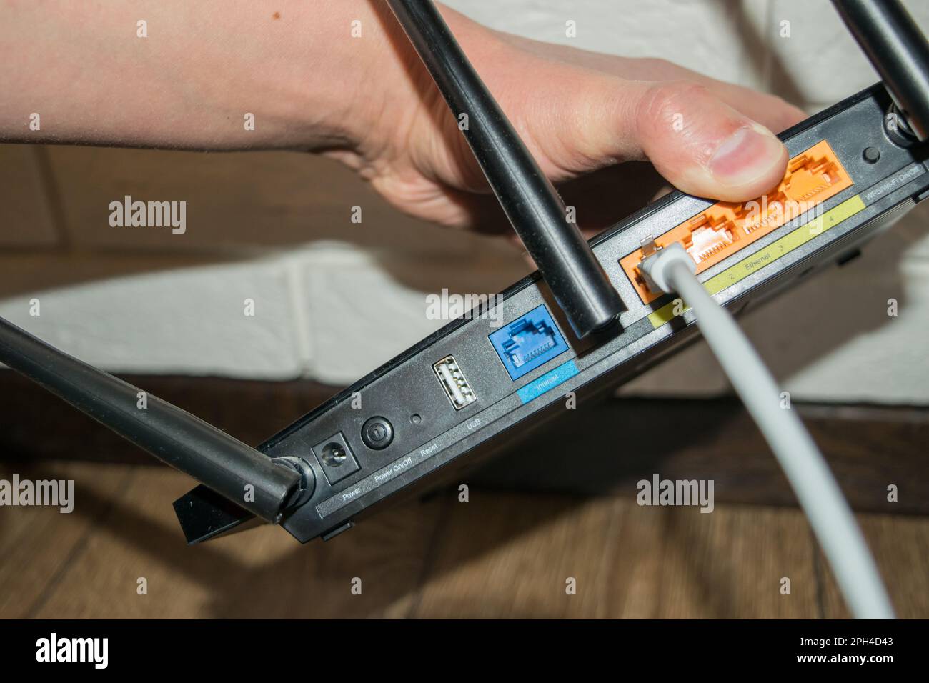 WiFi router, back of the router, hand holding the router with wires ...