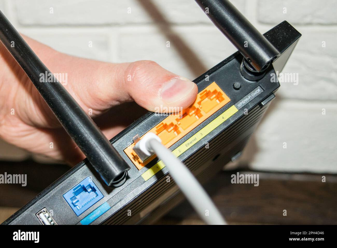 WiFi router, back of the router, hand holding the router with wires ...