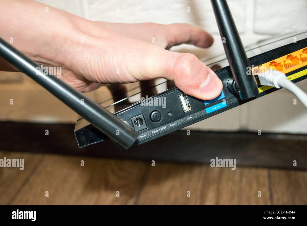 WiFi router, back of the router, hand holding the router with wires ...