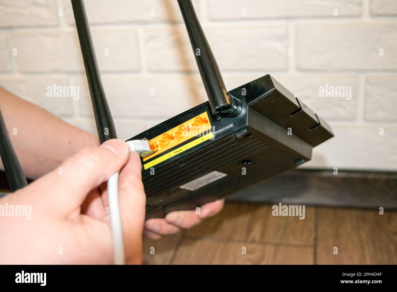 WiFi router, back of the router, hand holding the router with wires ...