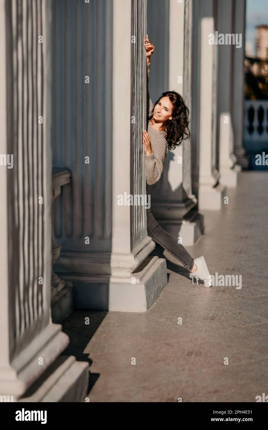 Woman building columns. An athletic woman in her 40s, dressed in a ...
