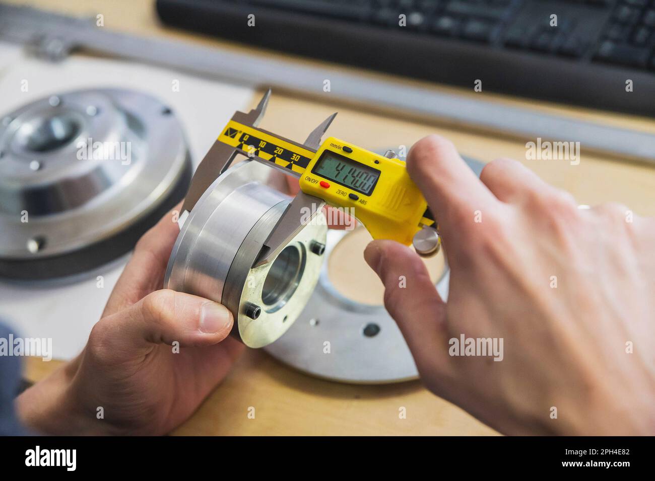 worker measures a metal part with a vernier caliper Stock Photo - Alamy