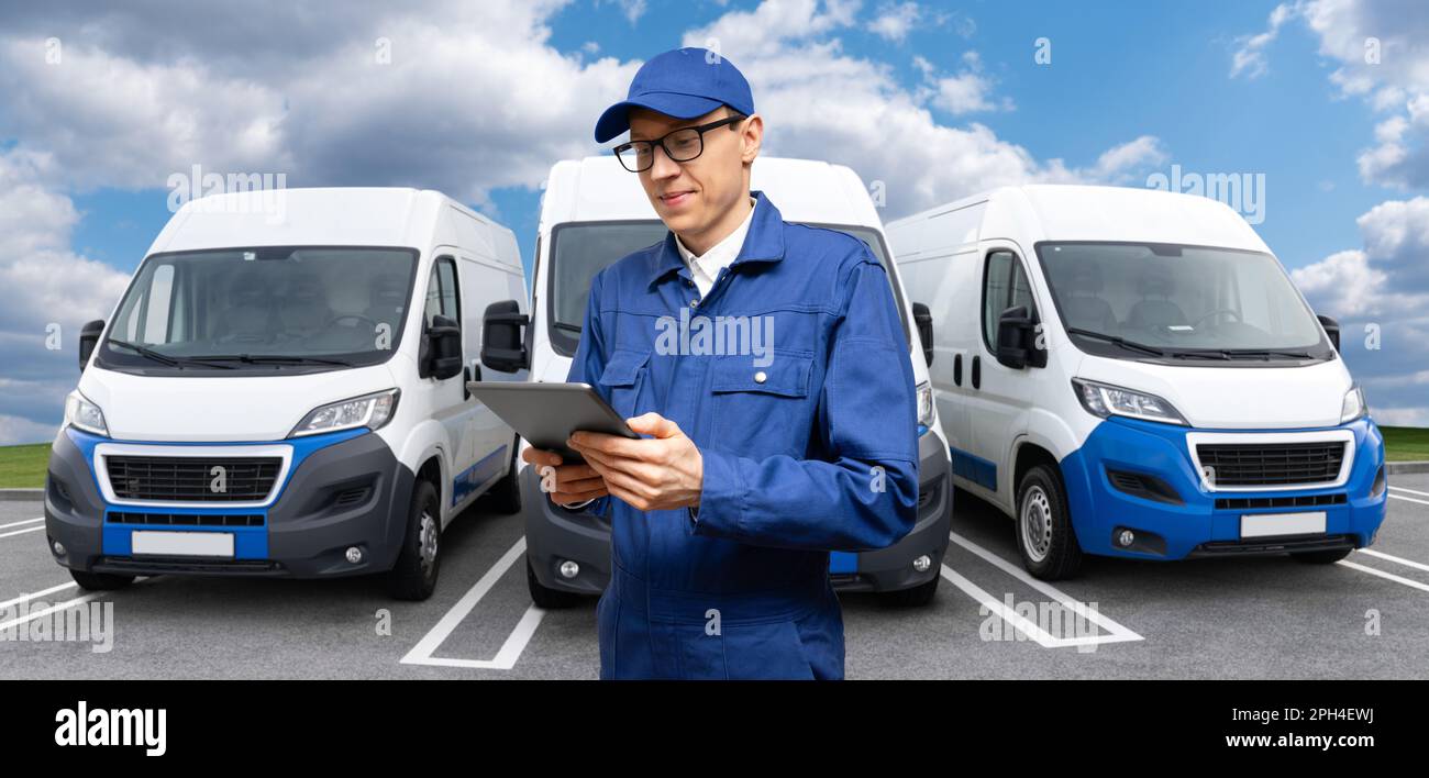 Manager with a digital tablet on the background of vans. Fleet ...